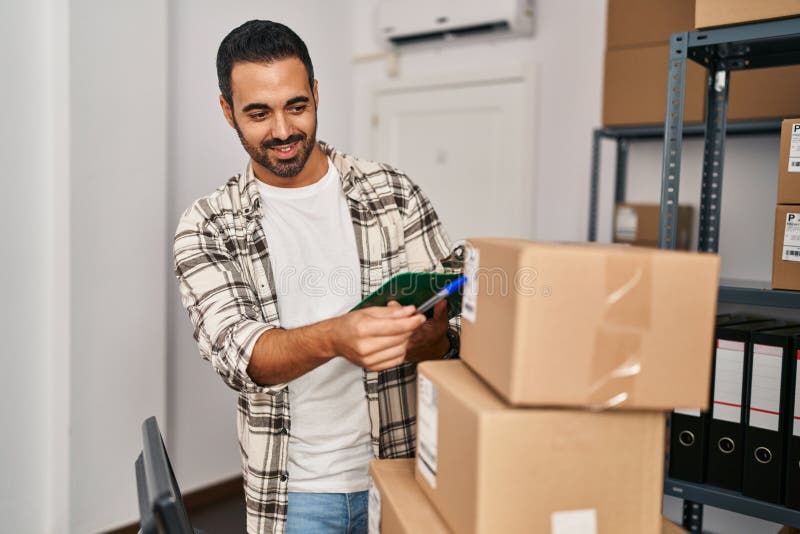 Young Hispanic Man Ecommerce Business Worker Reading Label Package at ...