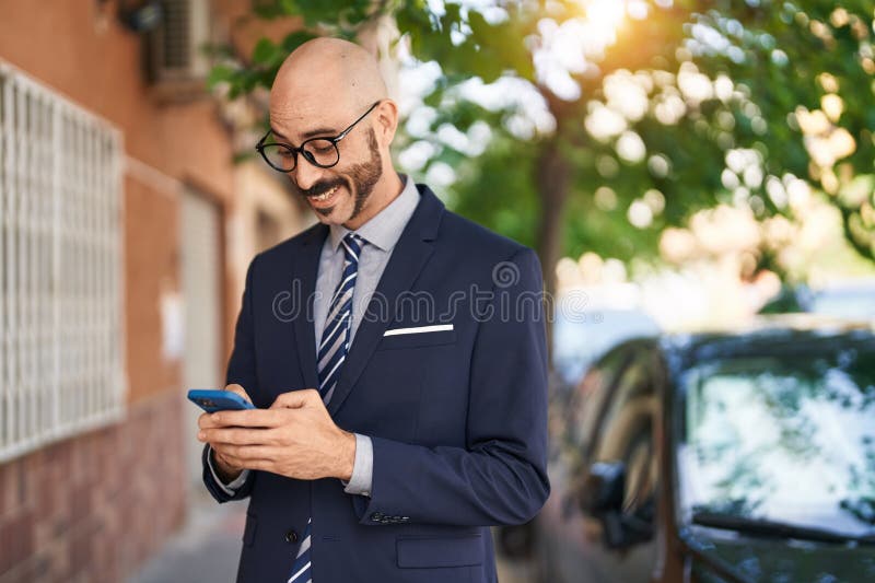 Young Hispanic Man Executive Smiling Confident Using Smartphone at ...