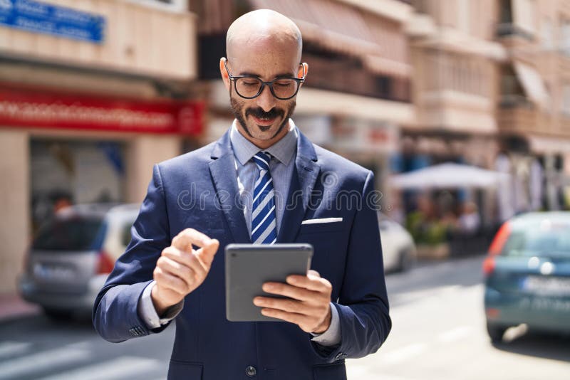 Young Hispanic Man Executive Smiling Confident Using Touchpad at Street ...