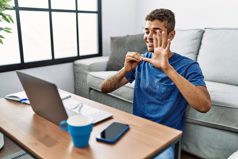 Young Hispanic Man Gesturing Sign Language on Video Call at Home Stock ...