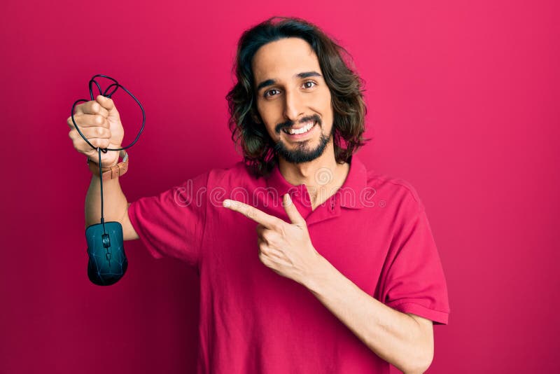 Young Hispanic Man Holding Mouse Computer Smiling Happy Pointing with ...