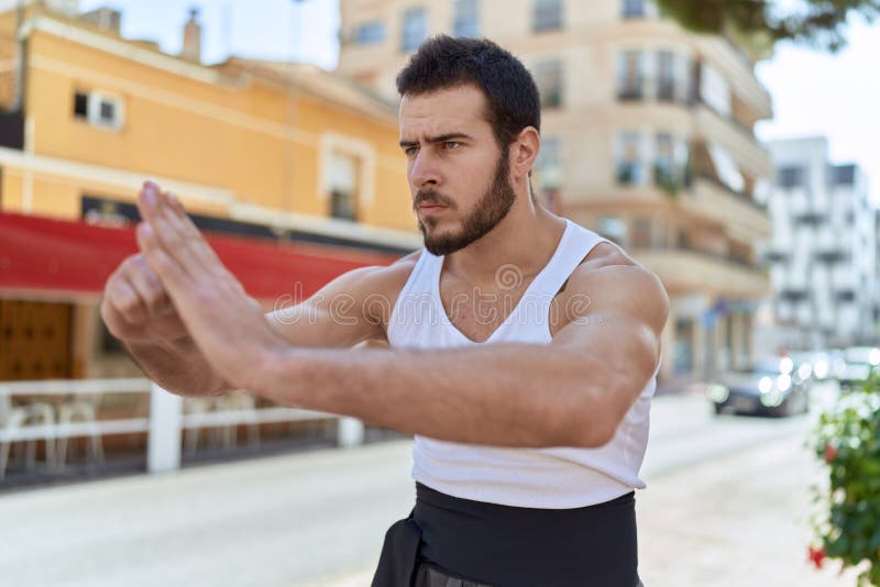 Young Hispanic Man Karate Fighter Doing Combat Salute at Street Stock ...
