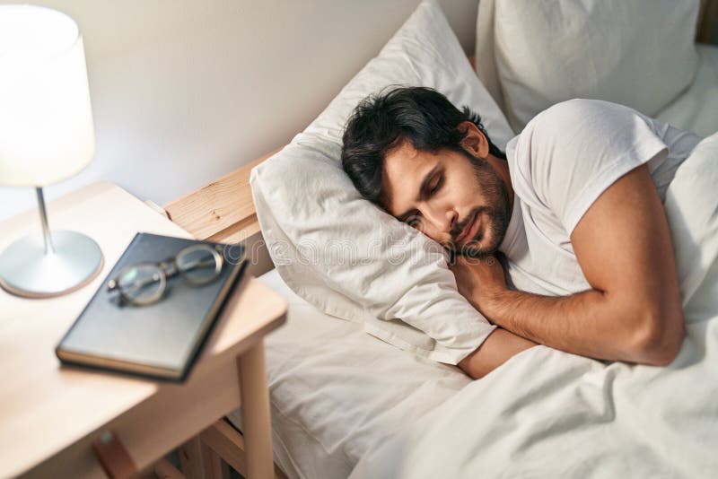 Young Hispanic Man Lying on Bed Sleeping at Bedroom Stock Image - Image ...
