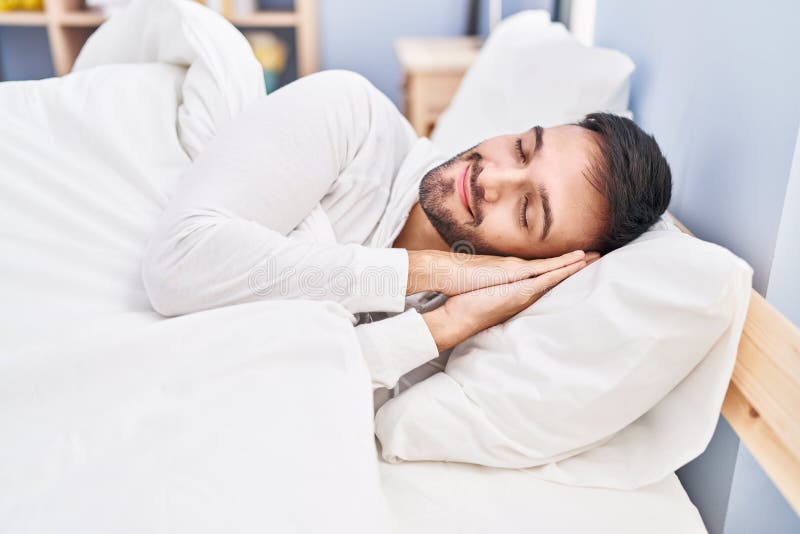 Young Hispanic Man Lying on Bed Sleeping at Bedroom Stock Photo - Image ...