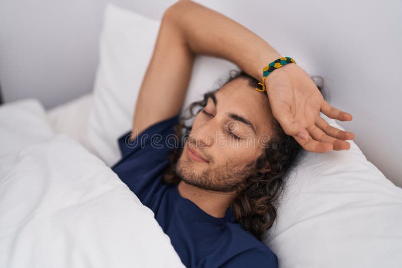 Young Hispanic Man Lying on Bed Sleeping at Bedroom Stock Image - Image ...