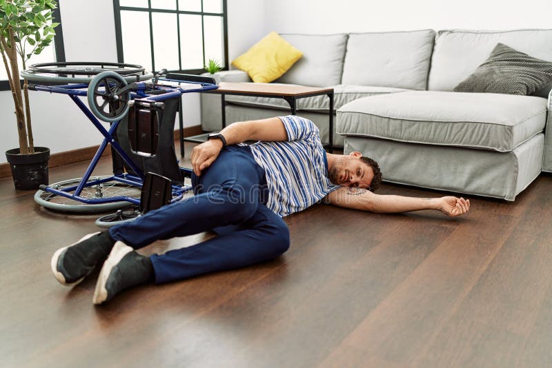 Young Hispanic Man Lying on Floor for Accident at Home Stock Photo ...