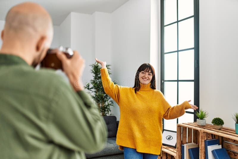 Young Hispanic Man Make Photo Using Camera To Woman at Home Stock Image ...