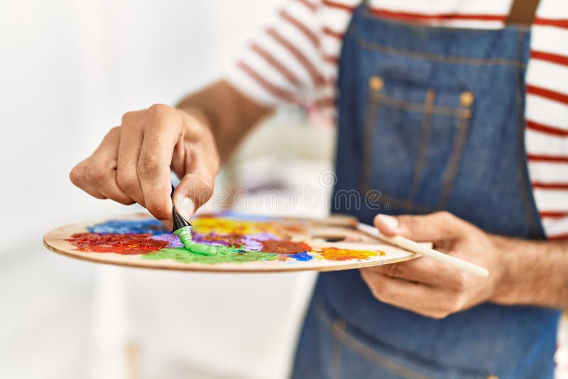 Young Hispanic Man Mixing Color on Palette at Art Studio Stock Photo ...
