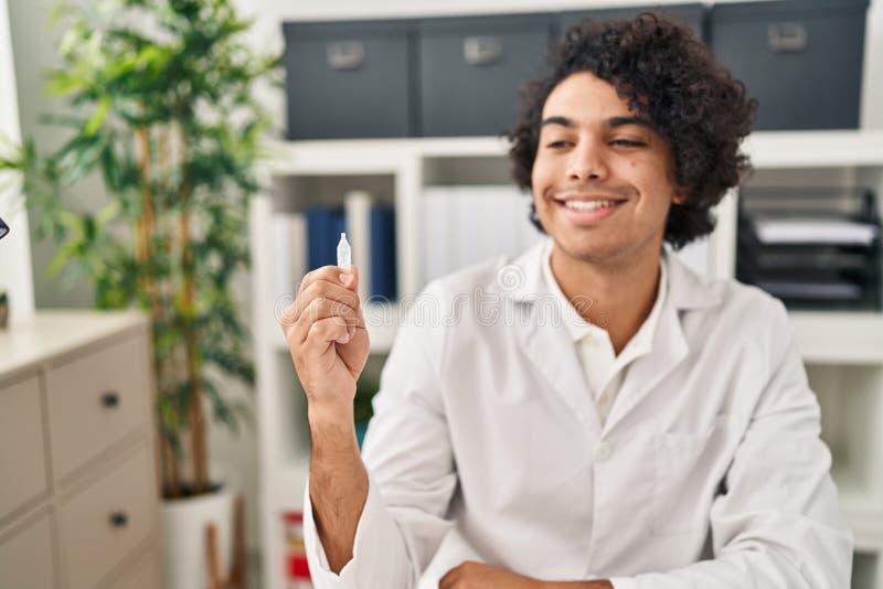 Young Hispanic Man Optician Holding Eye Drop at Clinic Stock Image ...