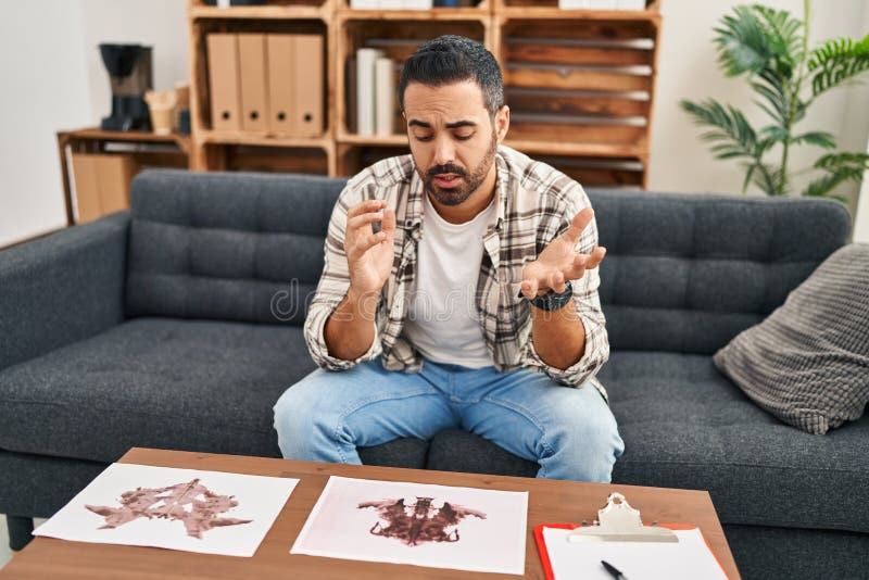 Young Hispanic Man Patient Having Rorschach Test at Psychology Center ...