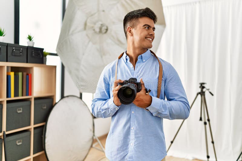 Young Hispanic Man Photographer Using Professional Camera at ...
