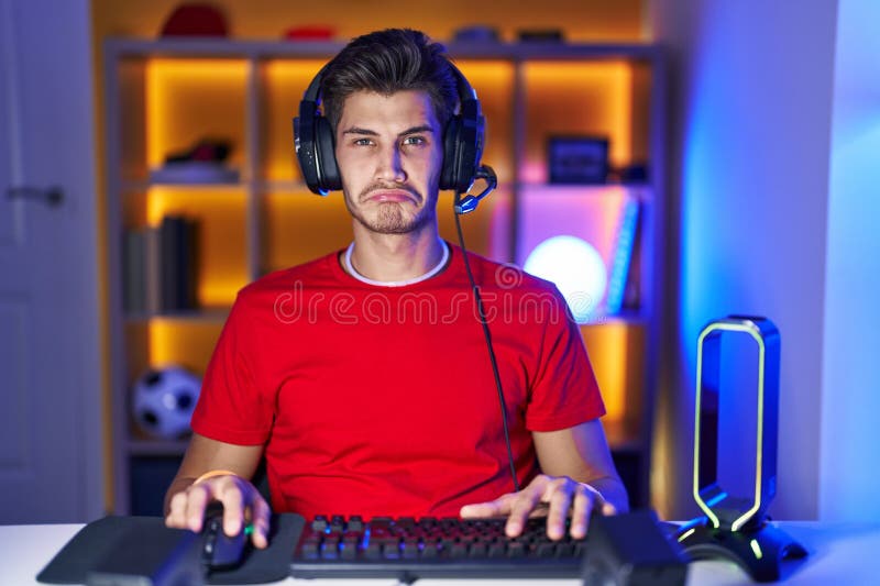 Young Hispanic Man Playing Video Games Depressed and Worry for Distress ...