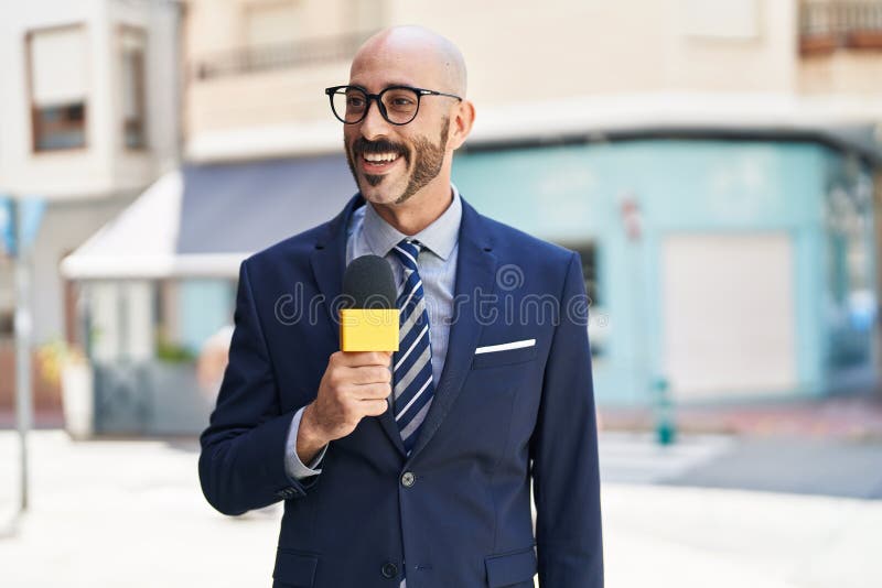 Young Hispanic Man Reporter Working Using Microphone at Street Stock ...