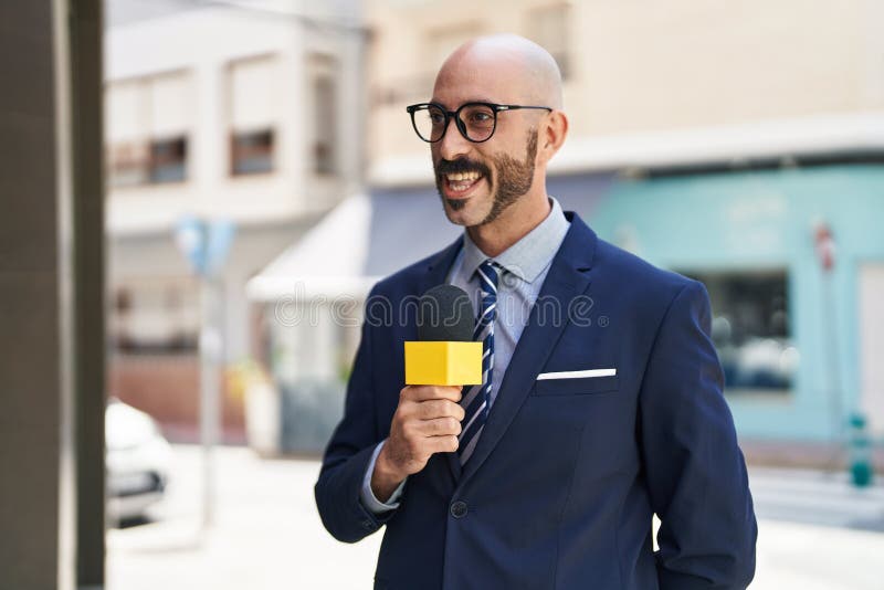 Young Hispanic Man Reporter Working Using Microphone at Street Stock ...