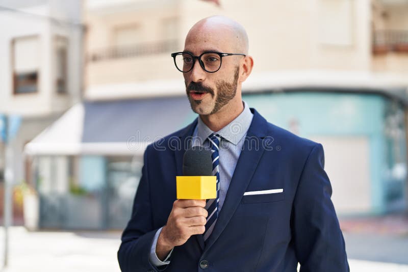 Young Hispanic Man Reporter Working Using Microphone at Street Stock ...