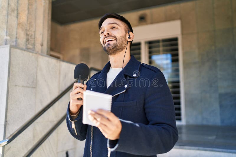 Young Hispanic Man Reporter Working Using Microphone at Street Stock ...
