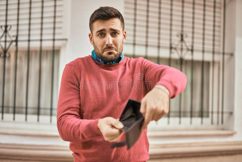 Young Hispanic Man with Sad Expression Showing Empty Wallet at the City ...