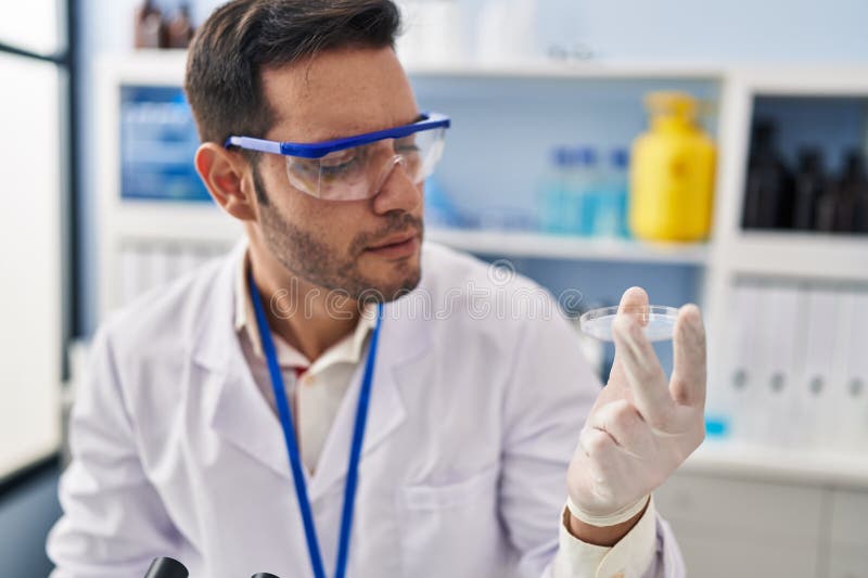 Young Hispanic Man Scientist Looking Sample at Laboratory Stock Image ...