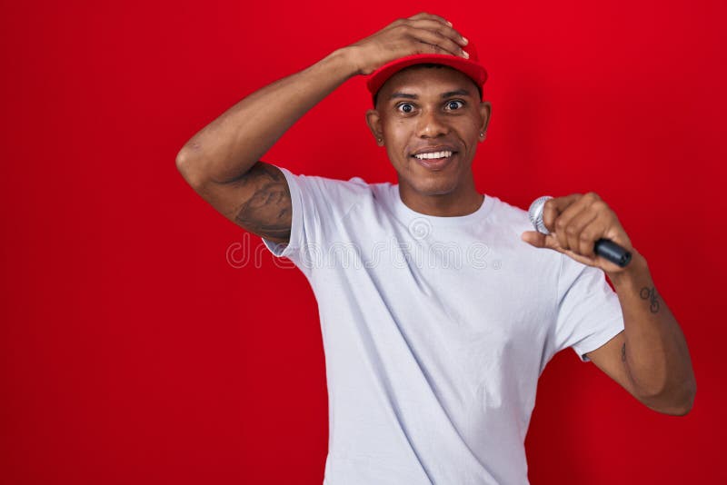 Young Hispanic Man Singing Song Using Microphone Stressed and ...