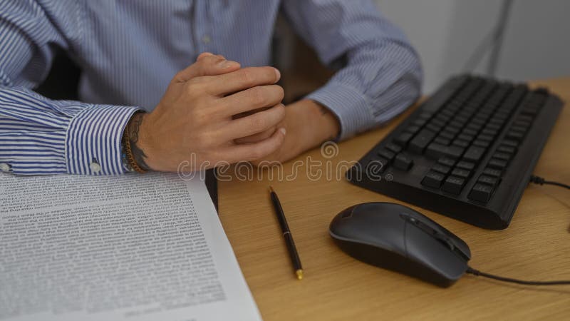 Young Hispanic Man Sitting in Office with Hands Together Over Documents ...