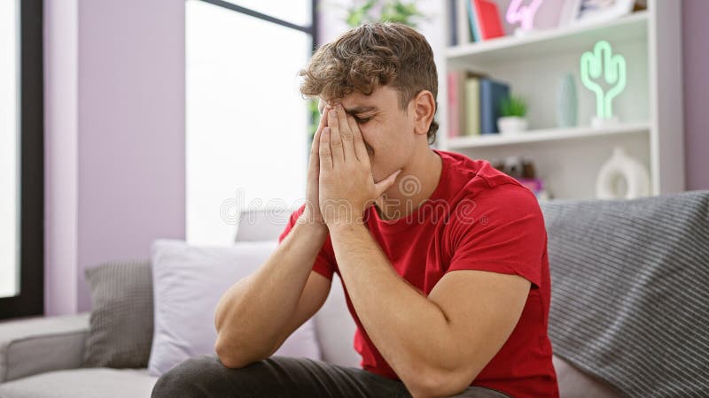 Young Hispanic Man Sitting on the Sofa Crying at Home Stock Image ...
