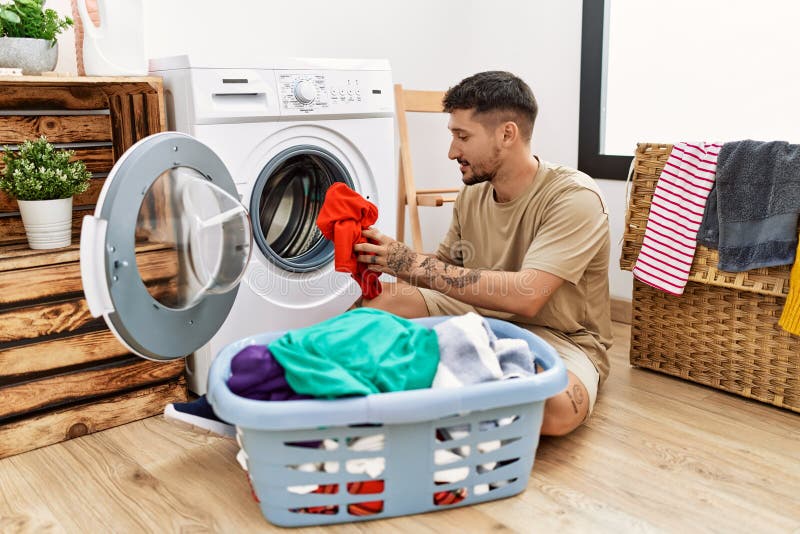 Young Hispanic Man Smilig Confident Using Washing Machine at Laundry ...