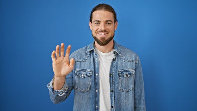 Young Hispanic Man Smiling Confident Saying Hello with Hand Over ...