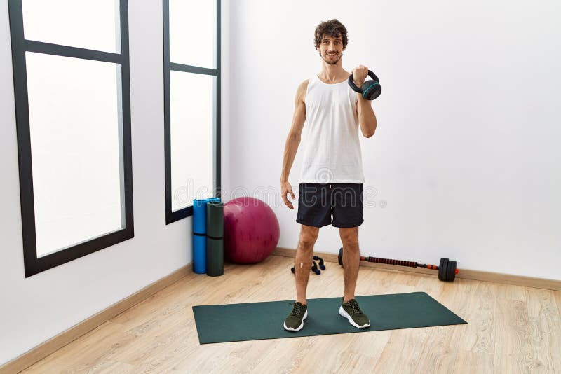 Young Hispanic Man Smiling Confident Training Using Kettlebell at Sport ...
