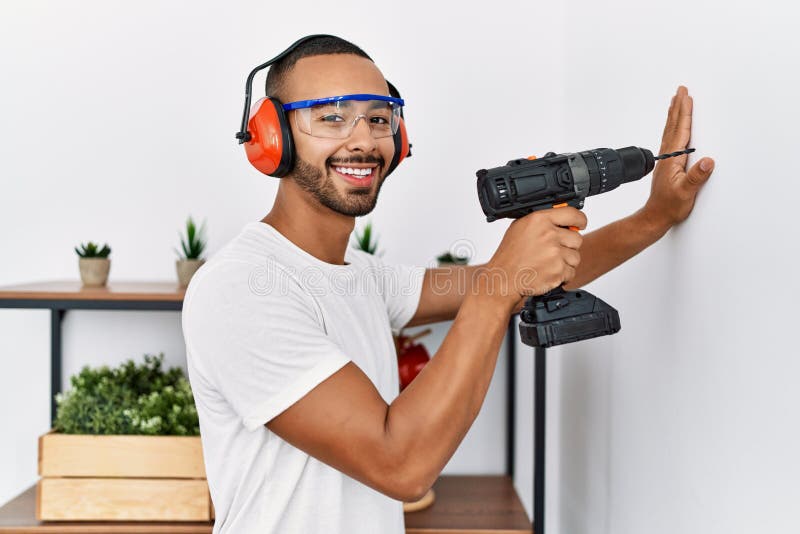Young Hispanic Man Smiling Confident Using Drill Home Stock Photos ...