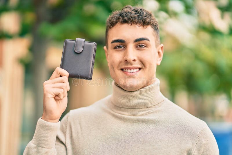 Young Hispanic Man Smiling Happy Holding Wallet at the City Stock Photo ...