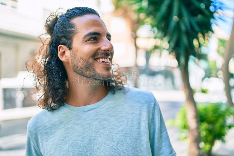 Young Hispanic Man Smiling Happy Looking To the Side at City Stock ...