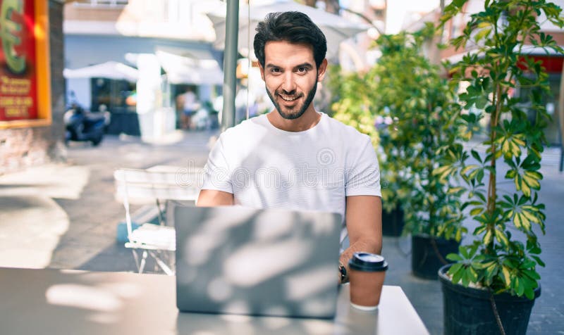 Young Hispanic Man Smiling Happy Working Using Laptop at Coffee Shop ...