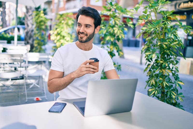 Young Hispanic Man Smiling Happy Working Using Laptop at Coffee Shop ...