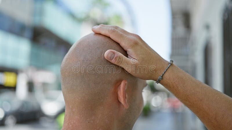 Young Hispanic Man Standing Backwards Touching Head at Street Stock ...