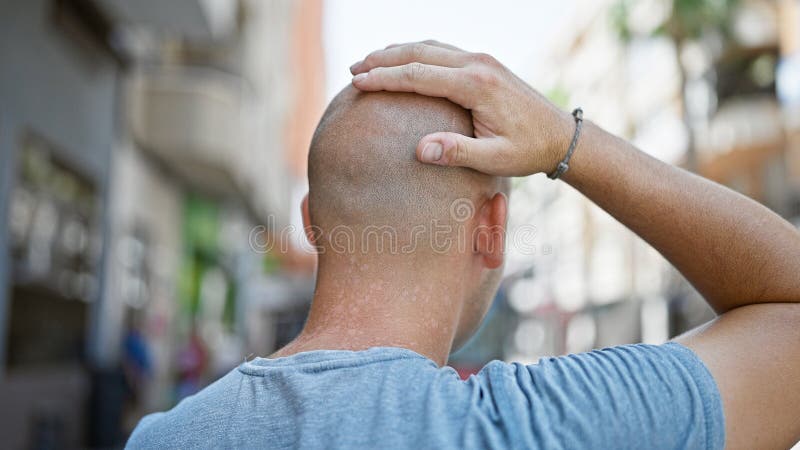 Young Hispanic Man Standing Backwards Touching Head at Street Stock ...