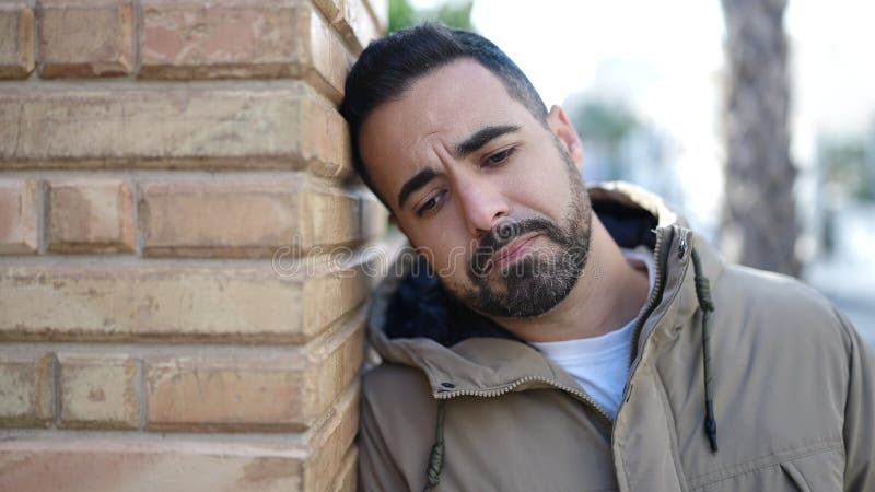 Young Hispanic Man Standing with Sad Expression at Street Stock Photo ...