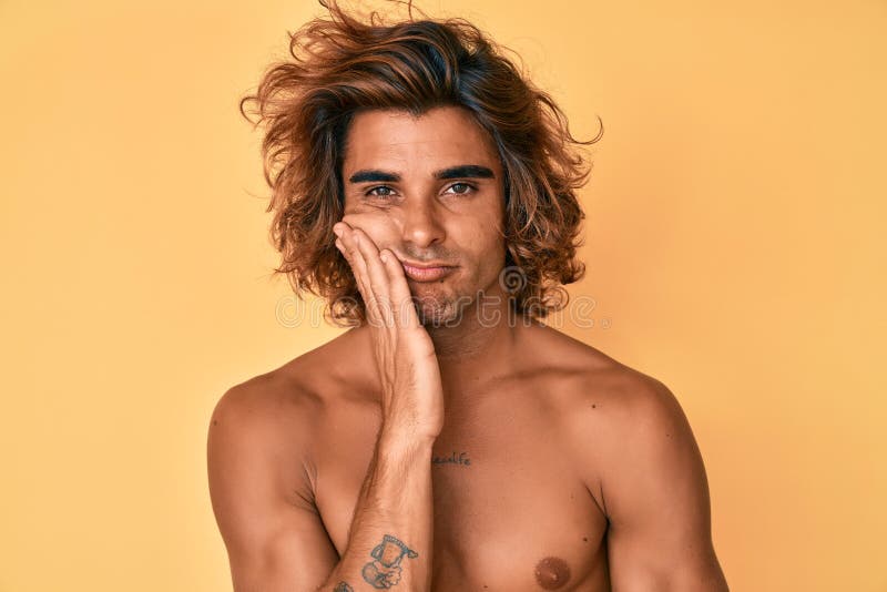 Young Hispanic Man Standing Shirtless Thinking Looking Tired and Bored ...