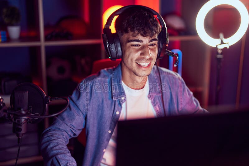 Young Hispanic Man Streamer Playing Video Game Using Computer at Gaming ...