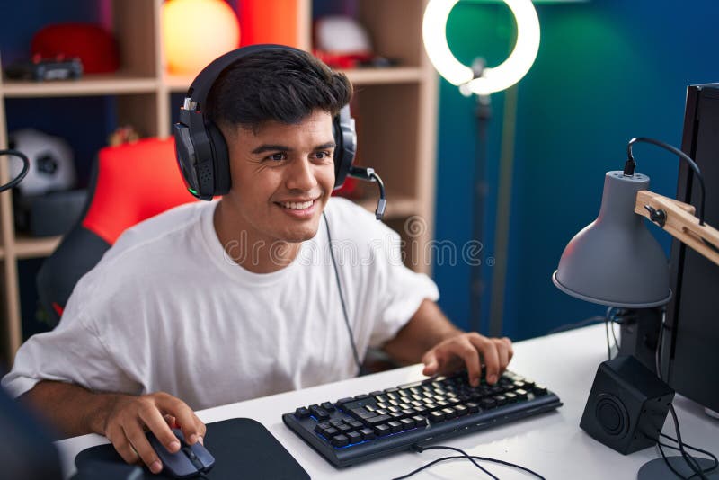 Young Hispanic Man Streamer Playing Video Game Using Computer at Gaming ...