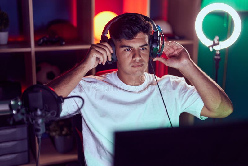 Young Hispanic Man Streamer Playing Video Game Using Computer at Gaming ...