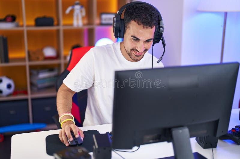 Young Hispanic Man Streamer Playing Video Game Using Computer at Gaming ...