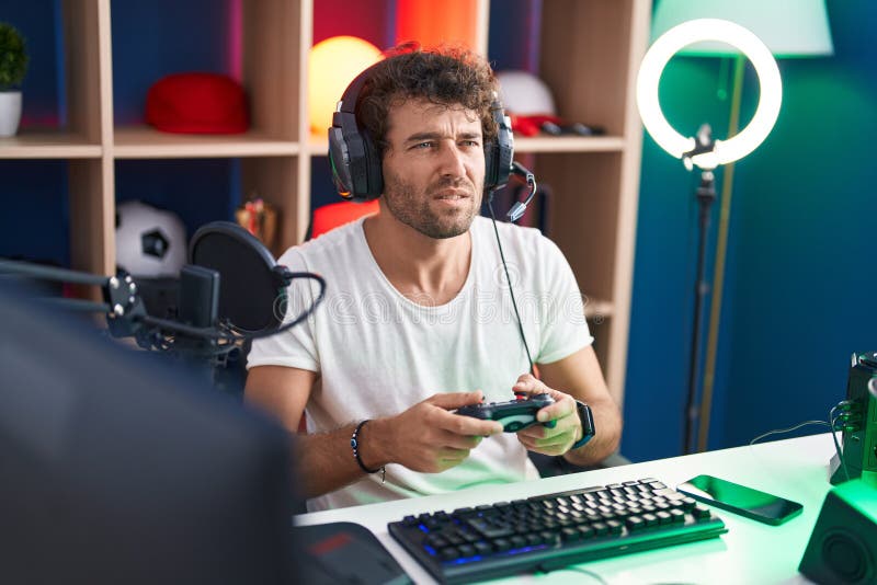 Young Hispanic Man Streamer Playing Video Game Using Joystick at Music ...