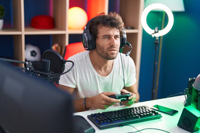 Young Hispanic Man Streamer Playing Video Game Using Joystick at Music ...