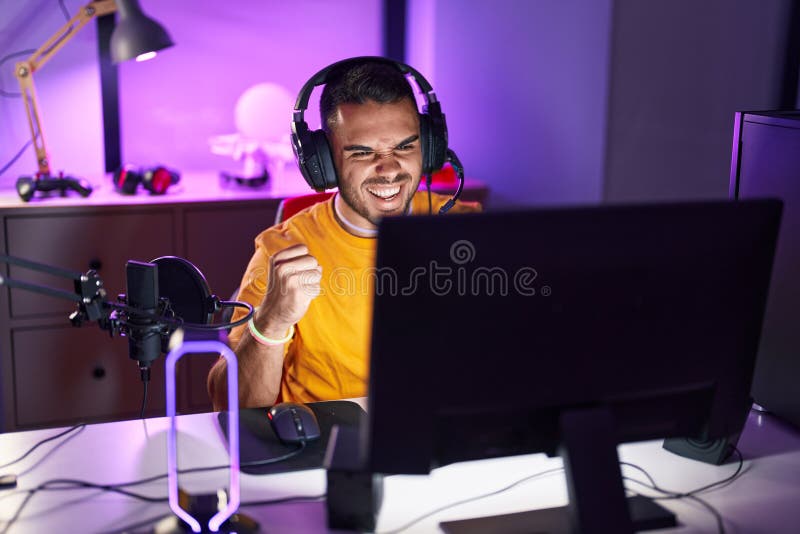 Young Hispanic Man Streamer Playing Video Game with Winner Expression ...