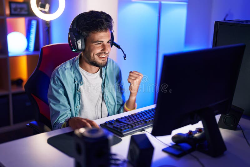 Young Hispanic Man Streamer Playing Video Game with Winner Expression ...