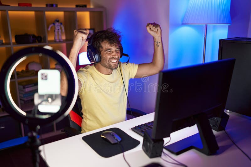 Young Hispanic Man Streamer Playing Video Game with Winner Expression ...