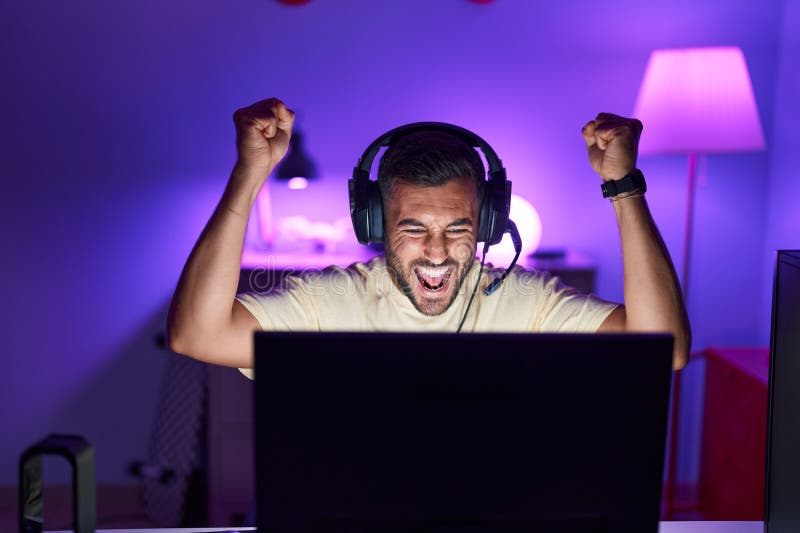 Young Hispanic Man Streamer Playing Video Game with Winner Expression ...