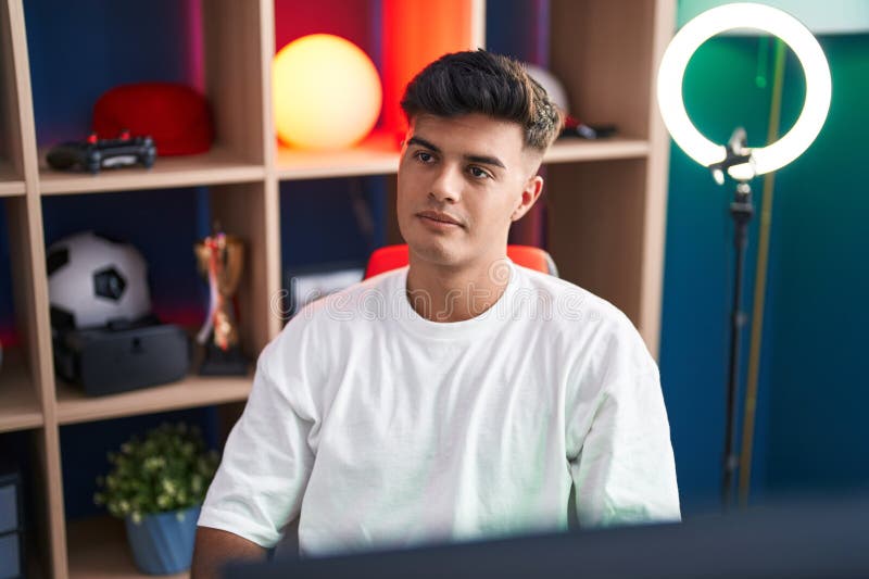 Young Hispanic Man Streamer Sitting on Table with Relaxed Expression at ...