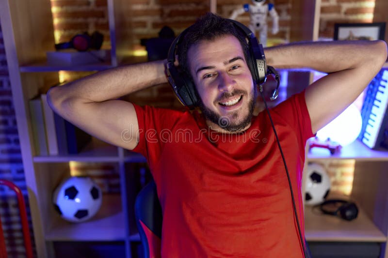 Young Hispanic Man Streamer Smiling Confident Relaxed with Hands on ...