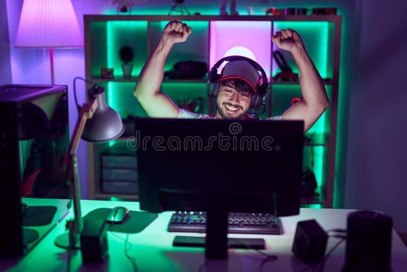 Young Hispanic Man Streamer Using Computer and Headphones with Winner ...